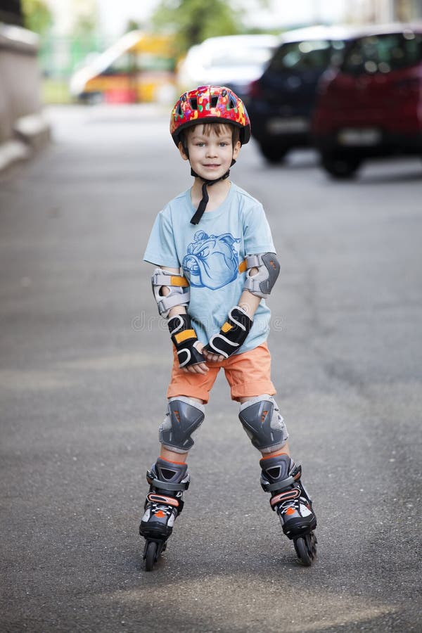 A boy is riding on rollers stock image. Image of leisure - 65605619