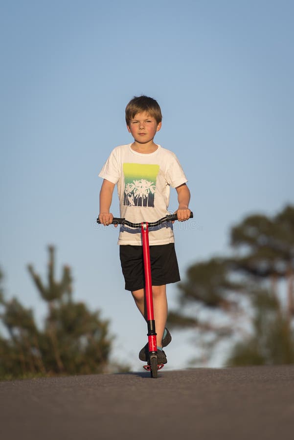 Boy riding a scooter stock image. Image of riding, blue - 40206689