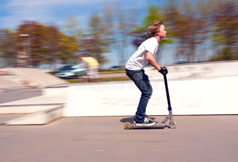 Boy Riding with Speed on a Scooter Stock Photo - Image of handsome ...