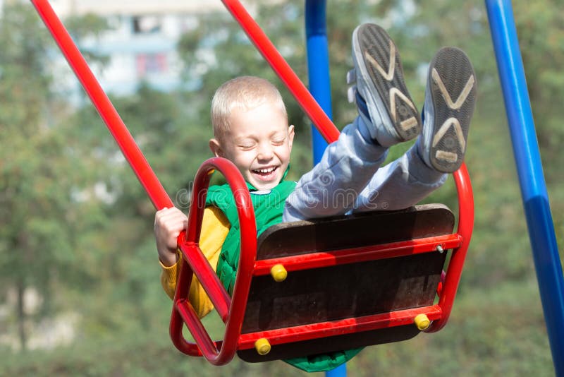 A Boy is Riding on a Swing. a Happy Weekend. Stock Image - Image of ...