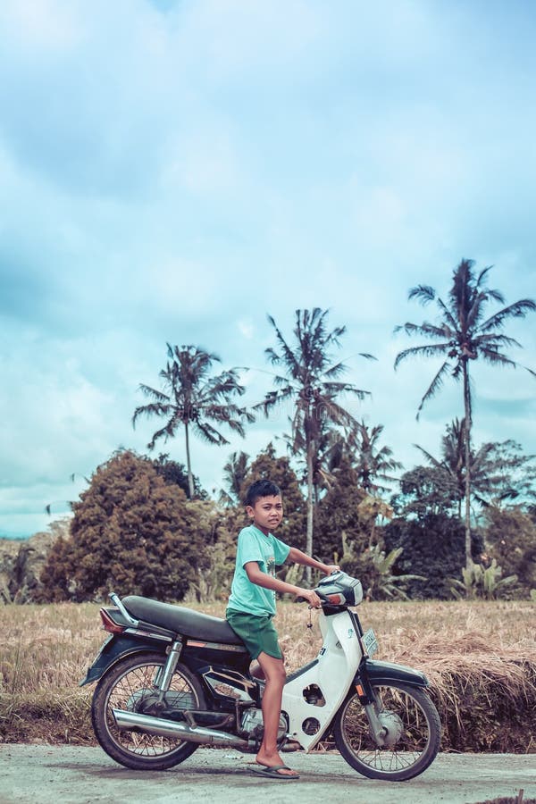 Boy Riding on White and Red Underbone Motorcycle Stock Image - Image of ...