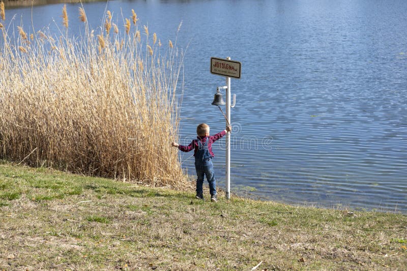 Boy Ringing in Blue Bell at Sunset in the Park Stock Image - Image of ...