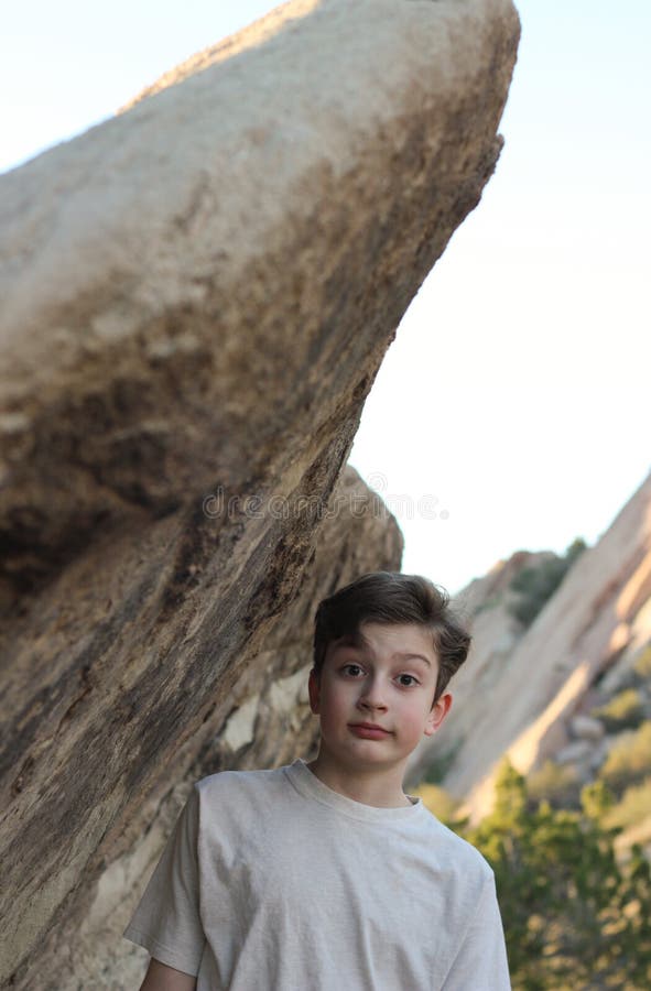 Boy and rock stock photo. Image of casually, outside - 10621136