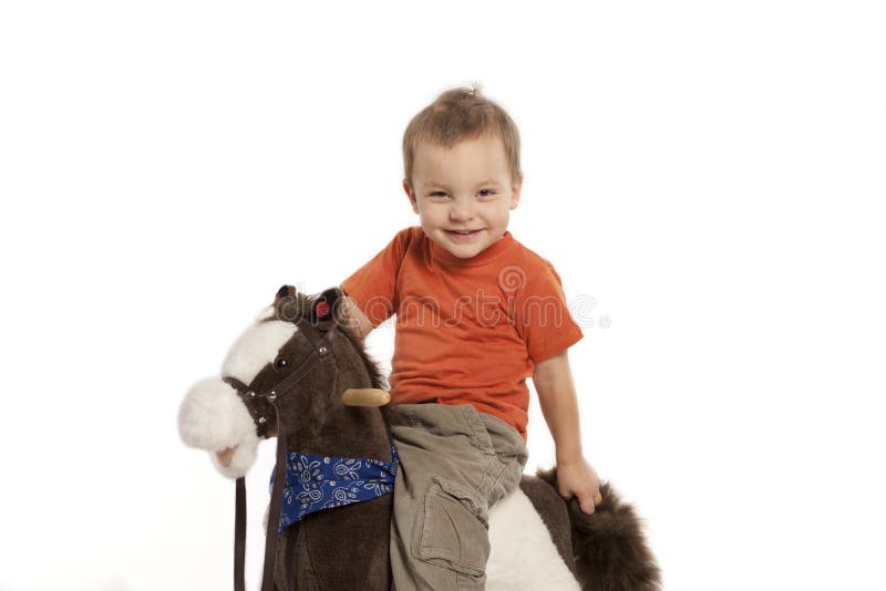 Boy and rocking horse stock image. Image of little, happinnes - 22056373