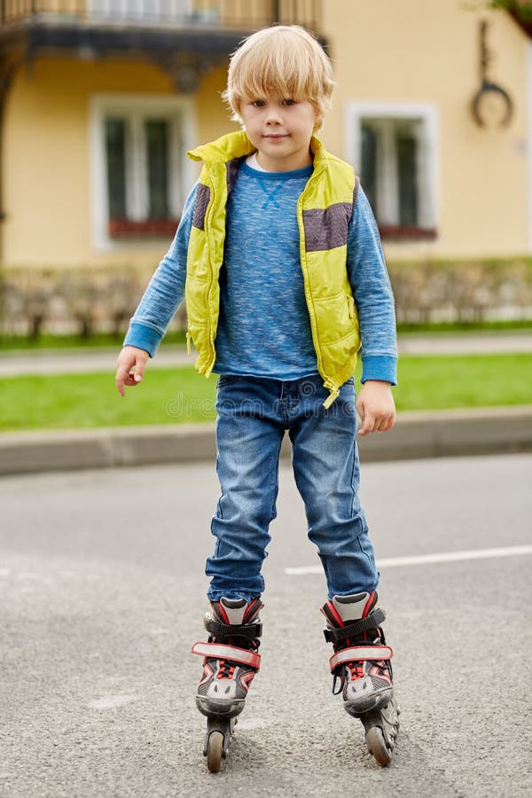 Boy on Roller Skates in Front of House on Stock Image - Image of lawn ...