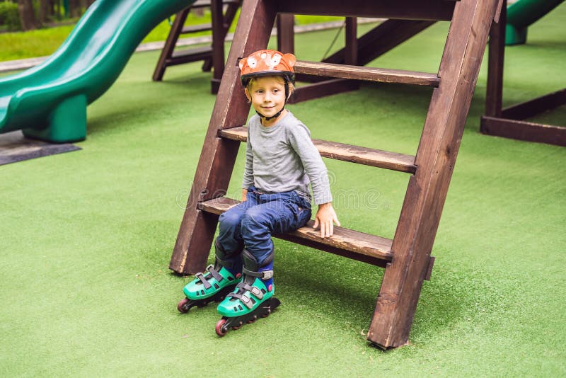 A Boy in Roller Skates on the Playground. the Boy Learns To Ride Roller ...