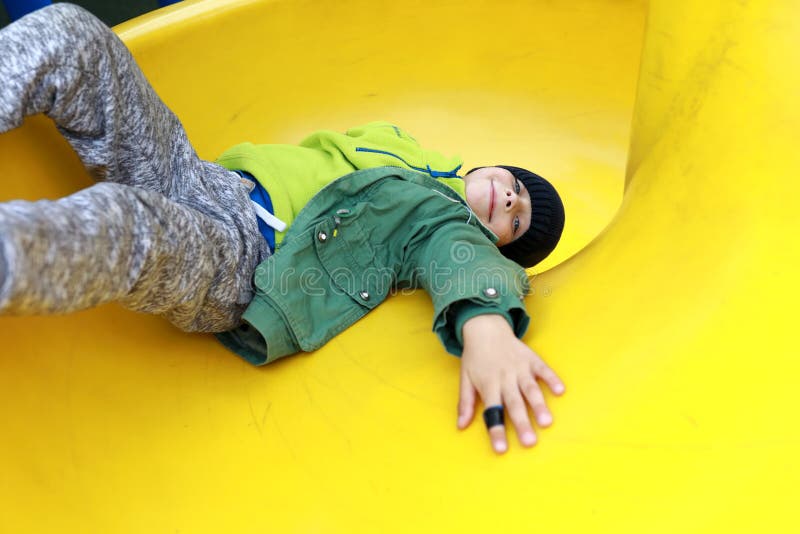Boy Rolling Down Spiral Slide Stock Photo - Image of playtime ...