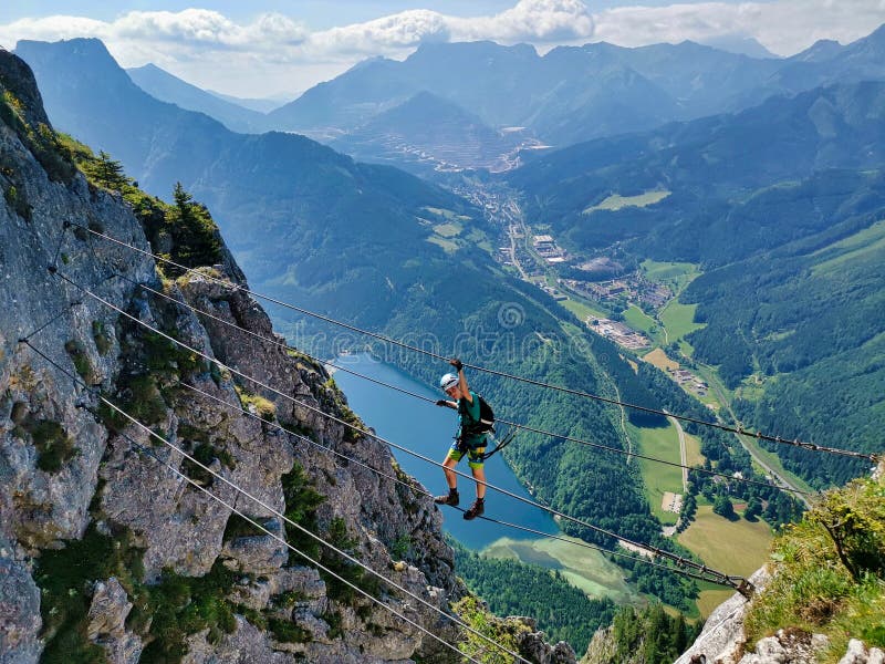 A Boy on a Rope Bridge High Above the Lake Stock Image - Image of ...