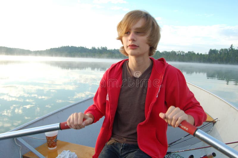 Boy Rowing a Boat stock image. Image of sunny, sweatshirt - 28084069