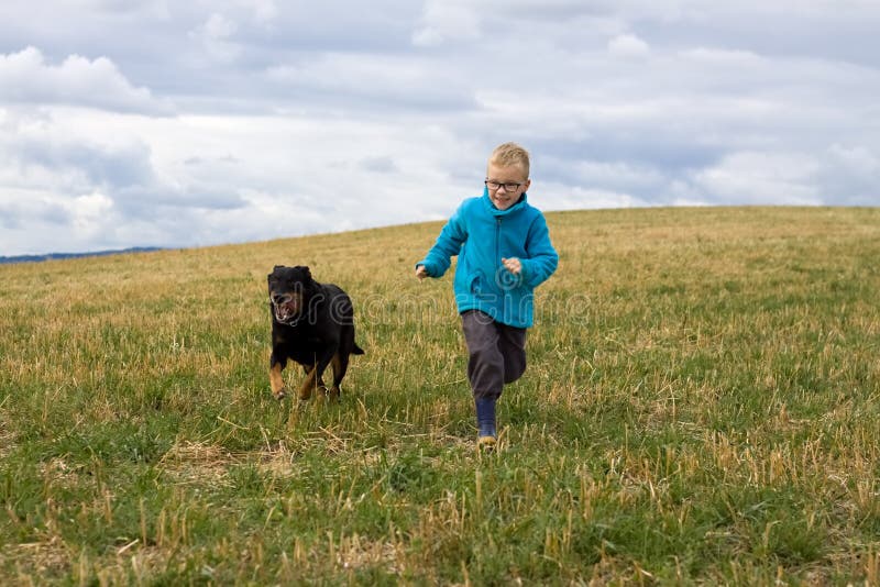 Boy run with dog stock photo. Image of eyeglasse, glasses - 59185886