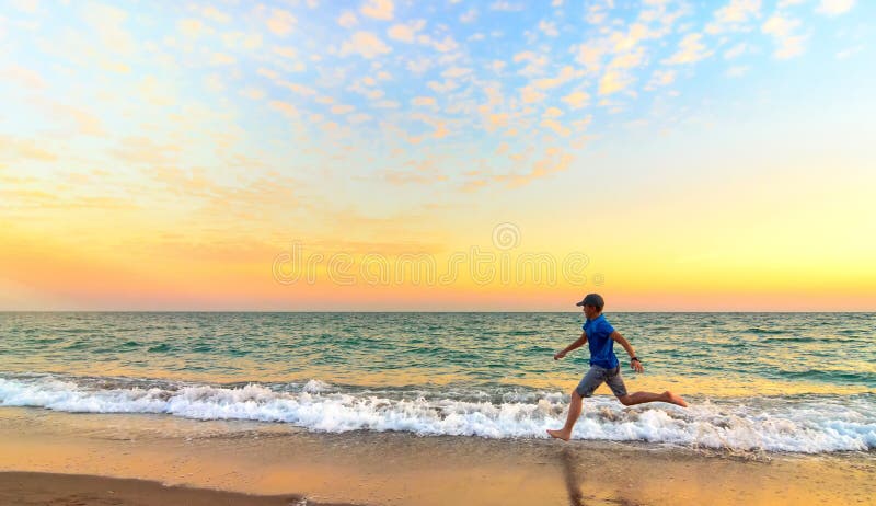 Boy Running Along the Beach at Sunset Stock Photo - Image of person ...