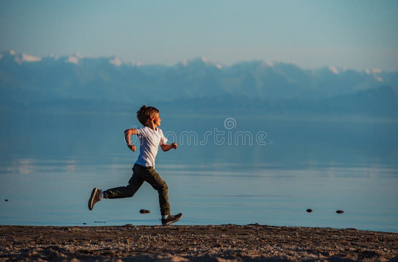 Boy Running Along the Lake Shore Stock Photo - Image of issyk ...
