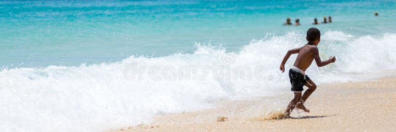 Boy running away from wave stock photo. Image of panoramic - 152924682