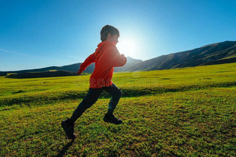 Boy Running through a Green Meadow Stock Photo - Image of rural ...