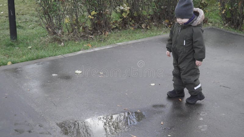 Puddle on City Sidewalk Reflects the Blue Sky, Clouds, and Street Signs ...