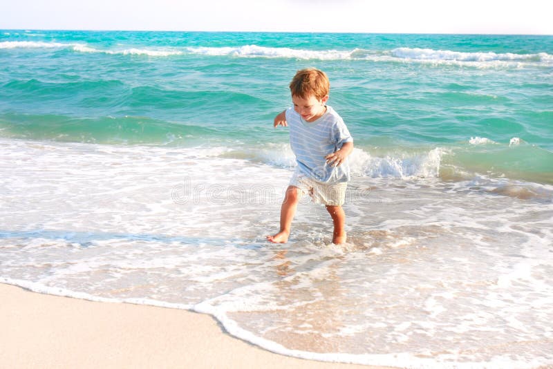 Boy running in the sea stock photo. Image of nature, cheerful - 14236330