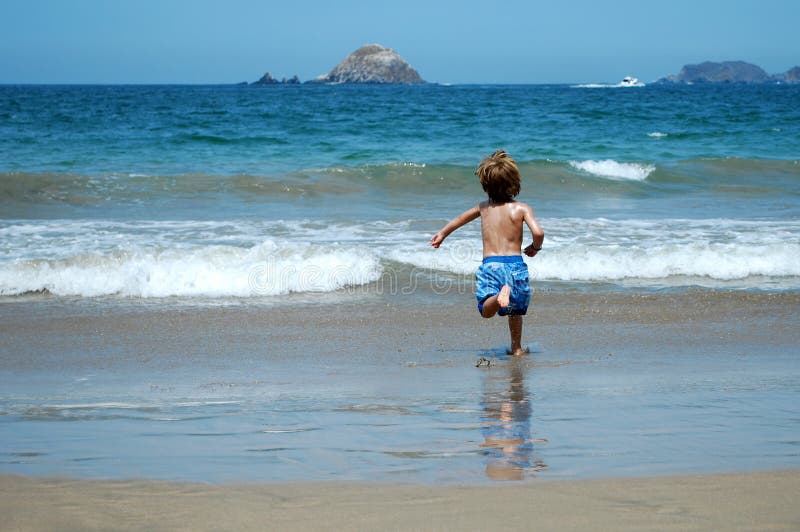 Boy running to the sea stock photo. Image of horizon - 19392034