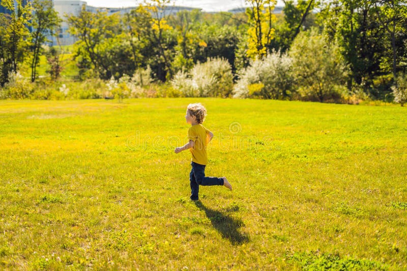 The Boy Runs in the Park on the Grass Stock Image - Image of nature ...