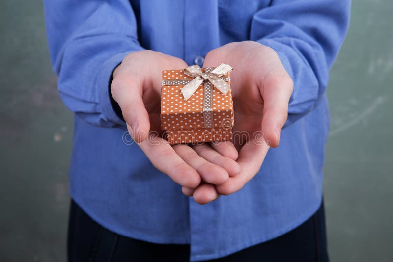 Boy& X27;s Hand Holding Small Gift Box with Polka Dots Stock Photo ...