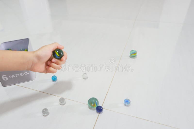 A Boy S Hand is Picking Up a Marble To Play with Stock Photo - Image of ...