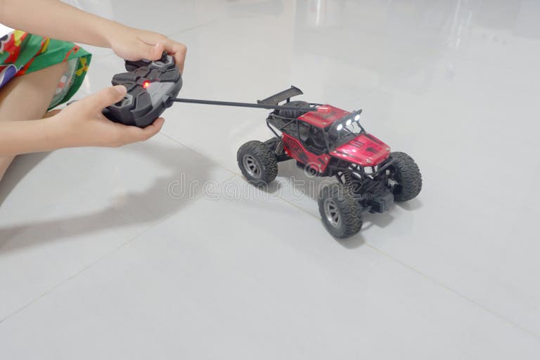 A Boy S Hand is Playing with a Remote Control Bigfoot Car Stock Image ...