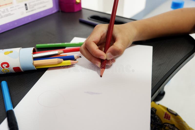 A Boy S Hand is Practicing Drawing Shapes on Paper Stock Image - Image ...