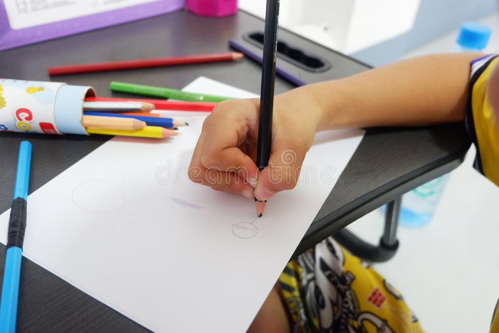 A Boy S Hand is Practicing Drawing Shapes on Paper Stock Photo - Image ...