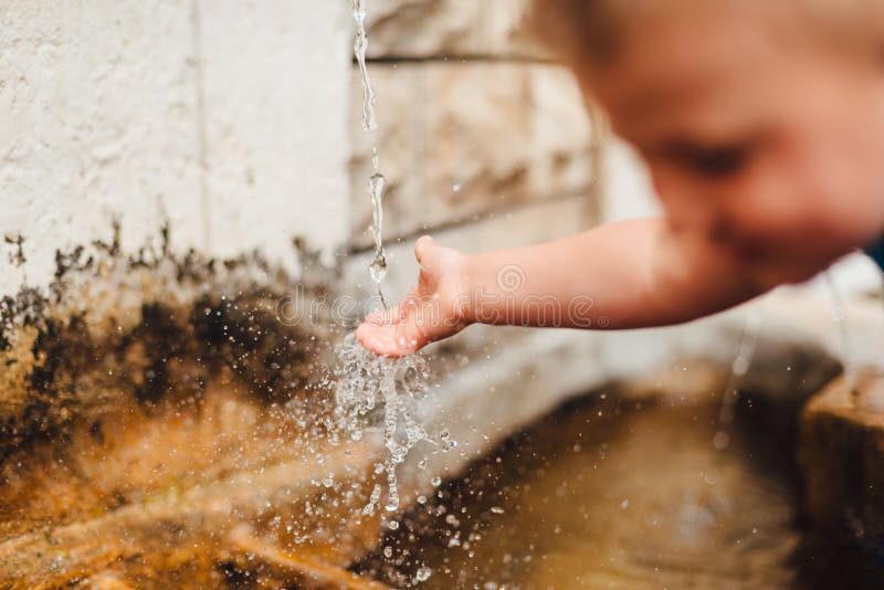 Boy`s Hand in the Stream of Splashing Water Stock Photo - Image of ...