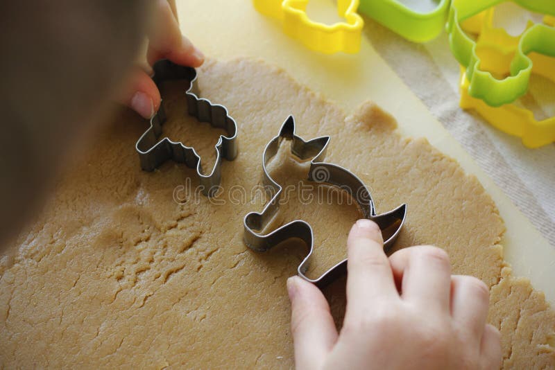 Boy S Hands Cutting Different Shapes Out of Rolled Gingerbread Dough ...