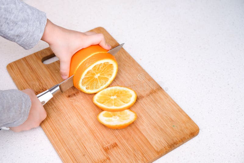 Boy`s Hands Cutting Fresh Orange on Kitchen Stock Photo - Image of ...