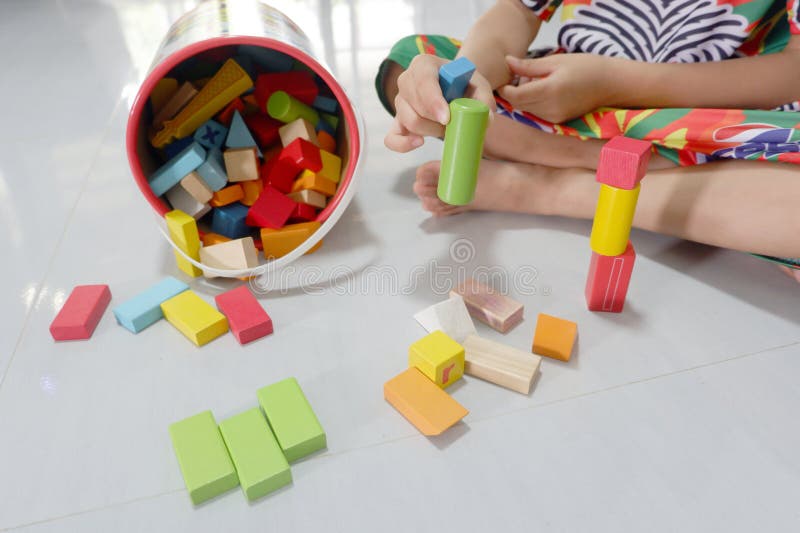 A Boy S Hands are Playing with Colorful Wooden Building Blocks Stock ...