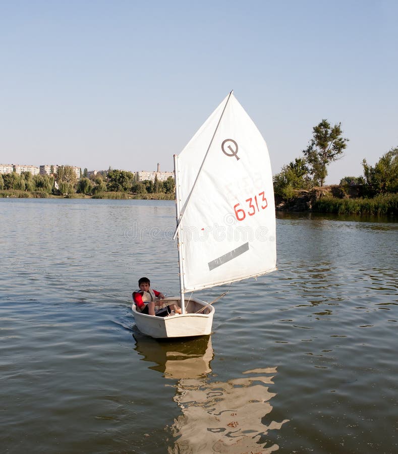 Boy in a sailing boat editorial image. Image of summer - 44497225