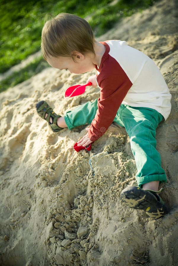 Boy and sand stock image. Image of jeans, green, kids - 91559533
