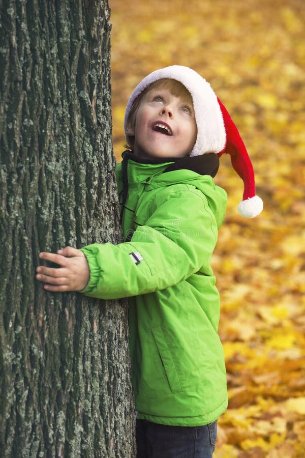 Boy with Santa hat in park stock image. Image of jacket - 62025557