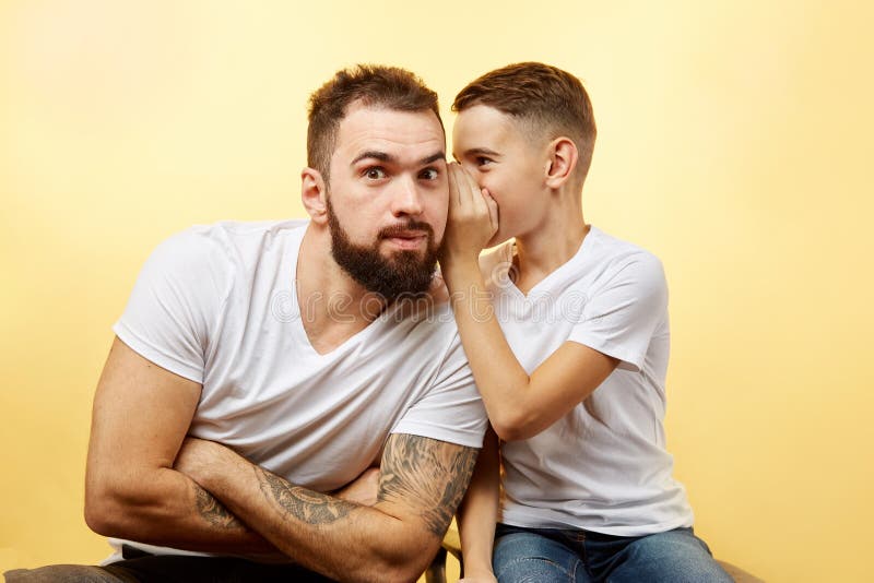 Boy Says Secret for His Father Isolated Onyellow Background Stock Photo ...