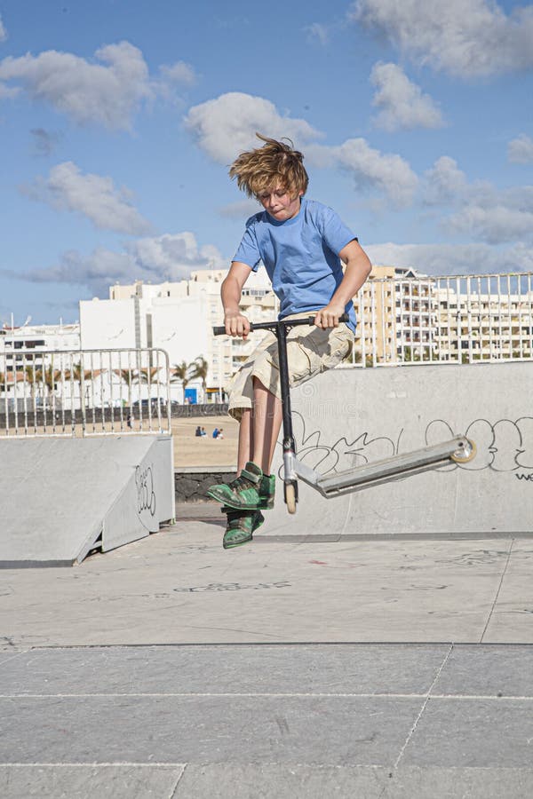 Boy with Scooter is Jumping at the Skate Park Stock Photo - Image of ...