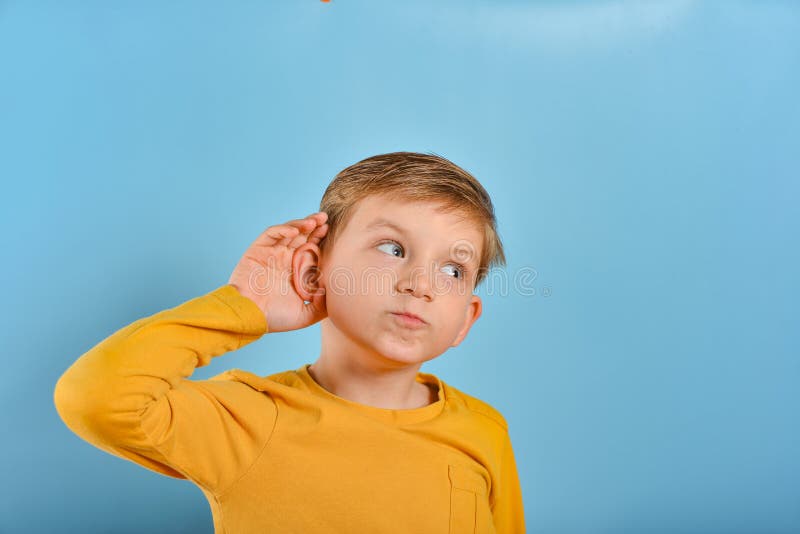 The Boy Scratches His Ear and Looks Sideways Stock Photo - Image of ...