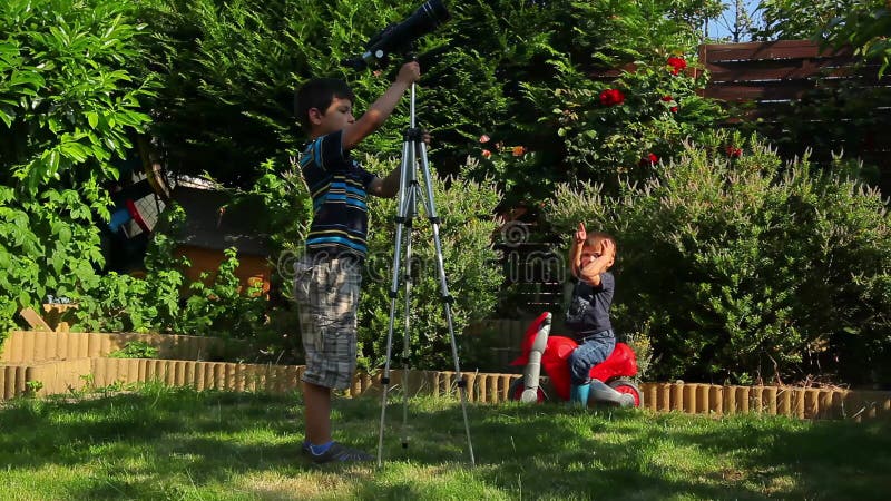 Boy Setting Up Telescope on Tripod and Pointing it To the Night Sky ...