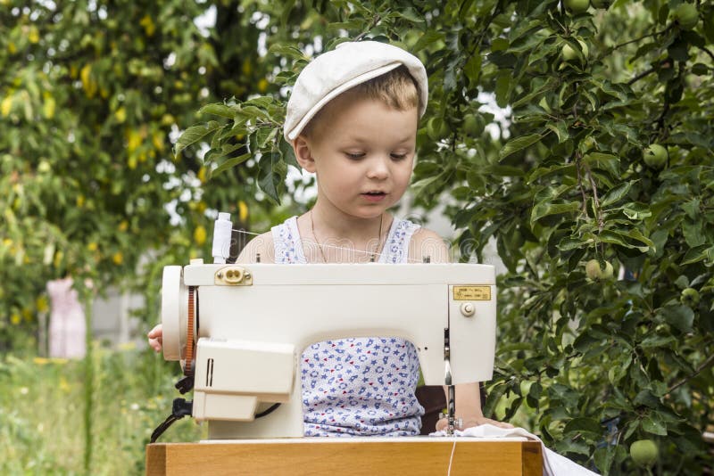 Boy Sews on the Sewing Machine Stock Photo - Image of nature, machine ...