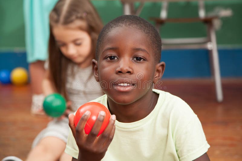 Boy sharing a plastic ball stock image. Image of child - 66718761