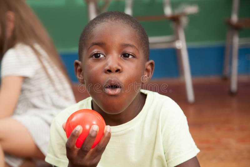 Boy sharing a plastic ball stock photo. Image of sharing - 66718960