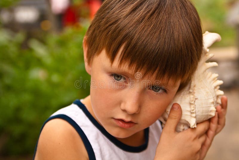 Boy with a shell stock photo. Image of listening, shell - 17400400