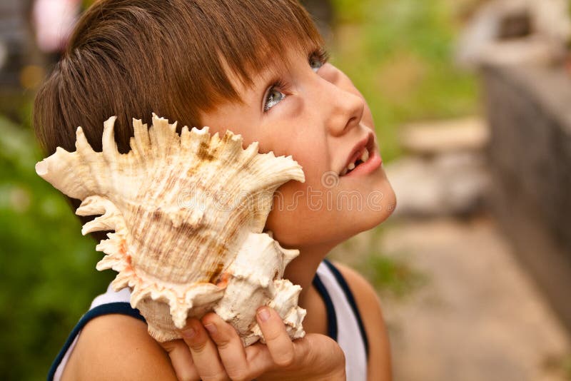 Boy with a shell stock image. Image of expressive, portrait - 17400437