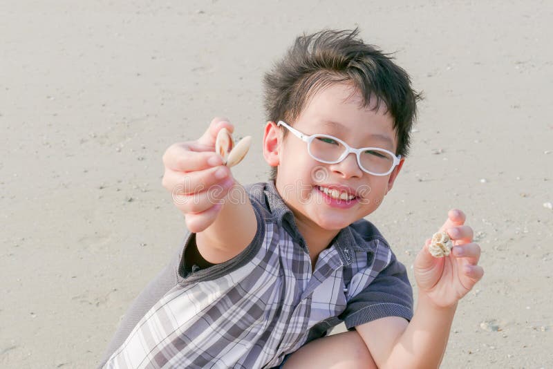 Boy with Shell on the Beach Stock Photo - Image of young, ocean: 71214178