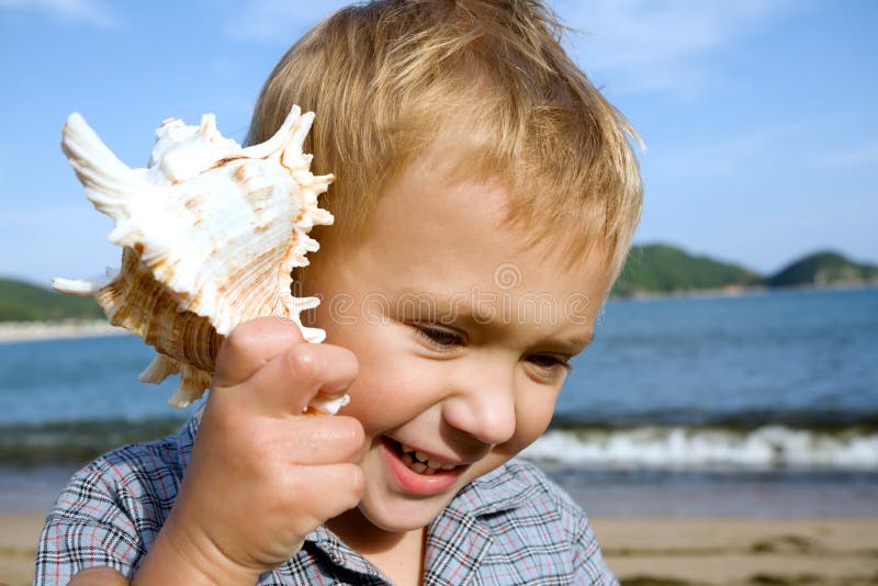 Boy.shell.sea stock image. Image of island, smiling, childhood - 4789453