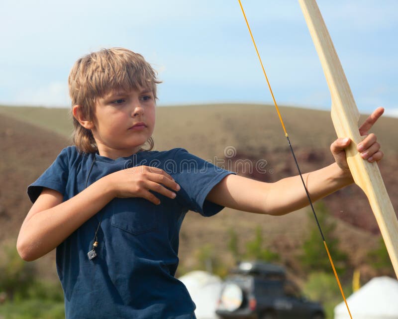 Boy Shoots a Bow at a Target Stock Photo - Image of caucasian, child ...