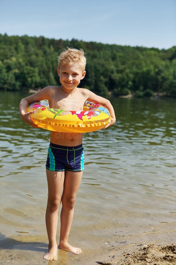 Boy on a Shore with a Floting Ring in Summer Stock Photo - Image of ...