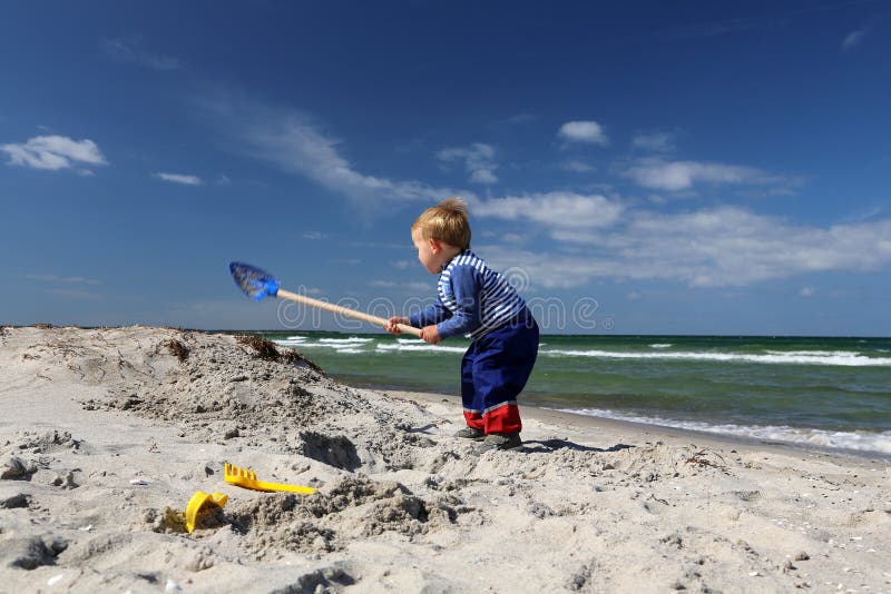 Boy with a Shovel at the Beach Stock Image - Image of beach, bucket ...