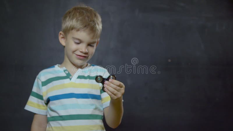 Boy Showing Skills by Flicking Fidget Spinners with Finger Stock ...