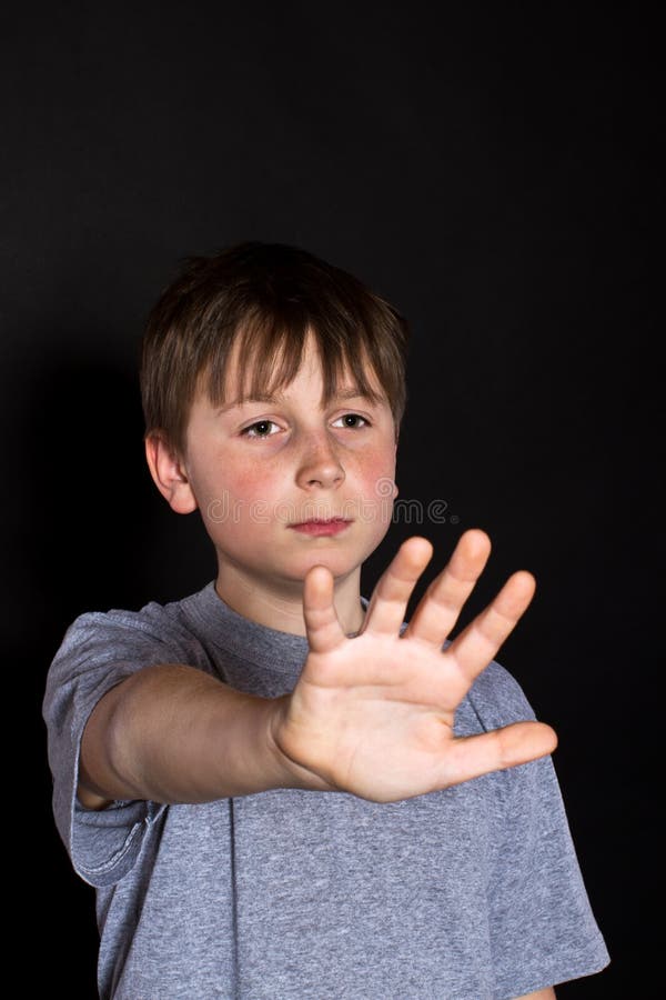 Boy shows his hand to stop stock photo. Image of male - 29075726